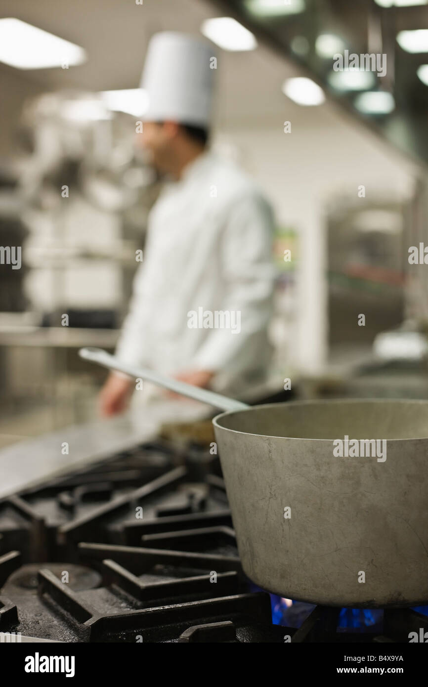 Chef and pot on stove Stock Photo - Alamy