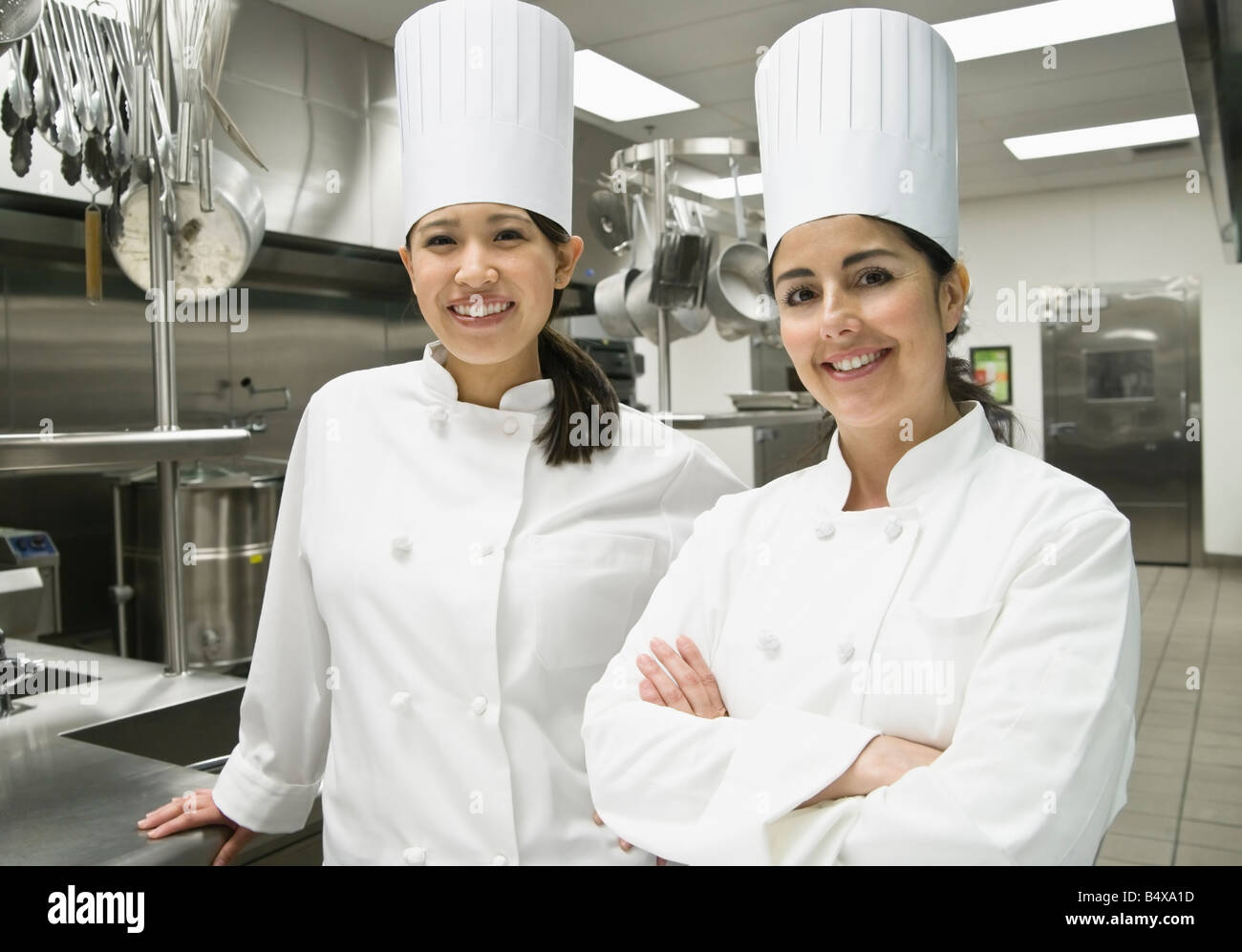 Female chefs posing in kitchen Stock Photo - Alamy