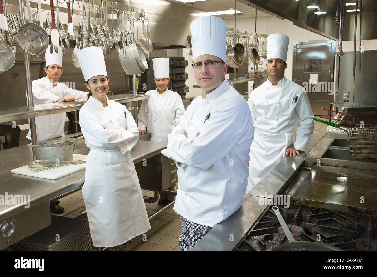 Chefs posing in kitchen Stock Photo - Alamy