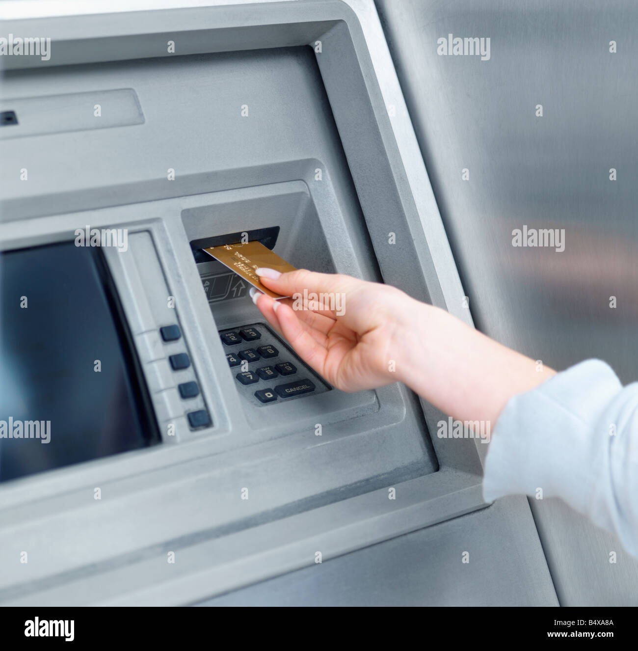 Woman using cash machine Stock Photo - Alamy