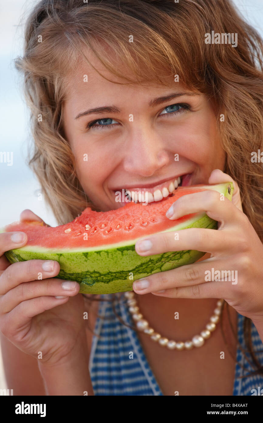 Young woman eating watermelon Stock Photo - Alamy