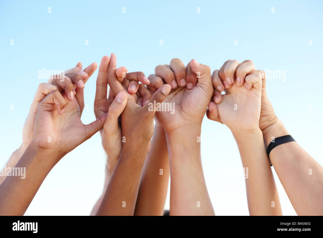 Hands clasped in solidarity Stock Photo - Alamy