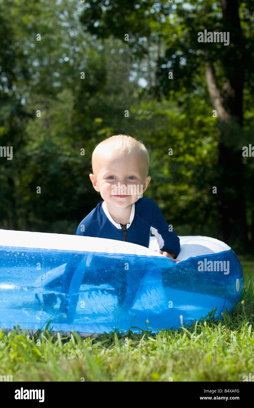 Baby boy playing in inflatable swimming pool Stock Photo - Alamy