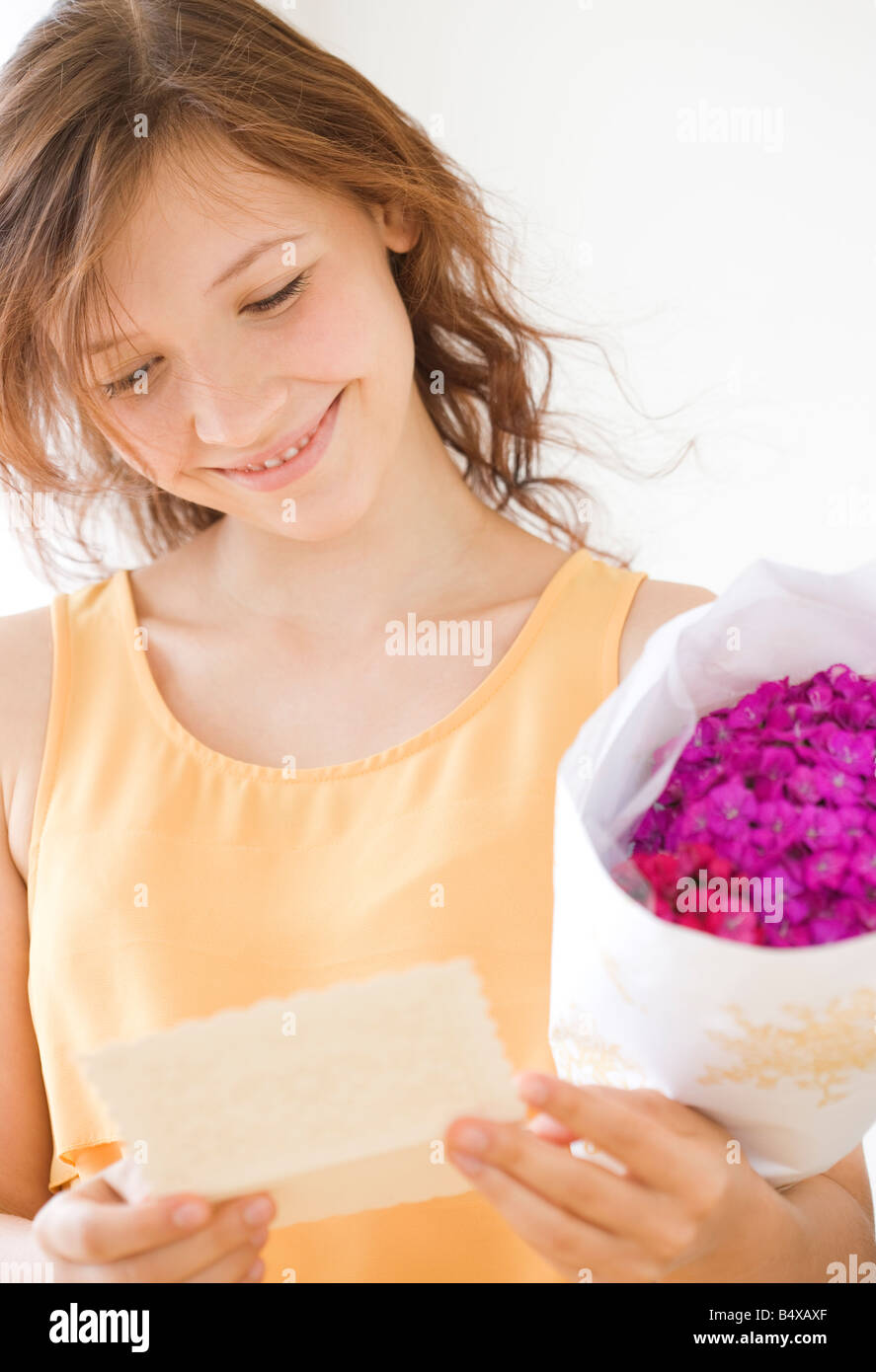 Teenage girl reading gift card Stock Photo - Alamy