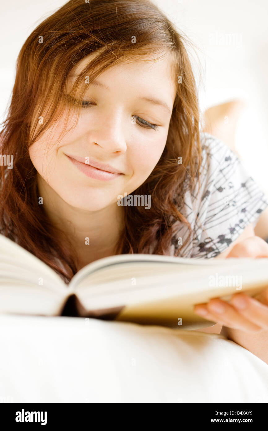 Teen reading book laying on bed hi-res stock photography and images - Alamy