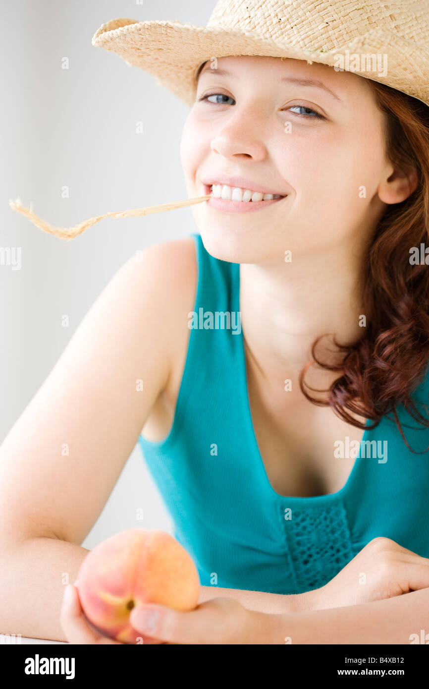 Teenage girl chewing on wheat stalk Stock Photo - Alamy