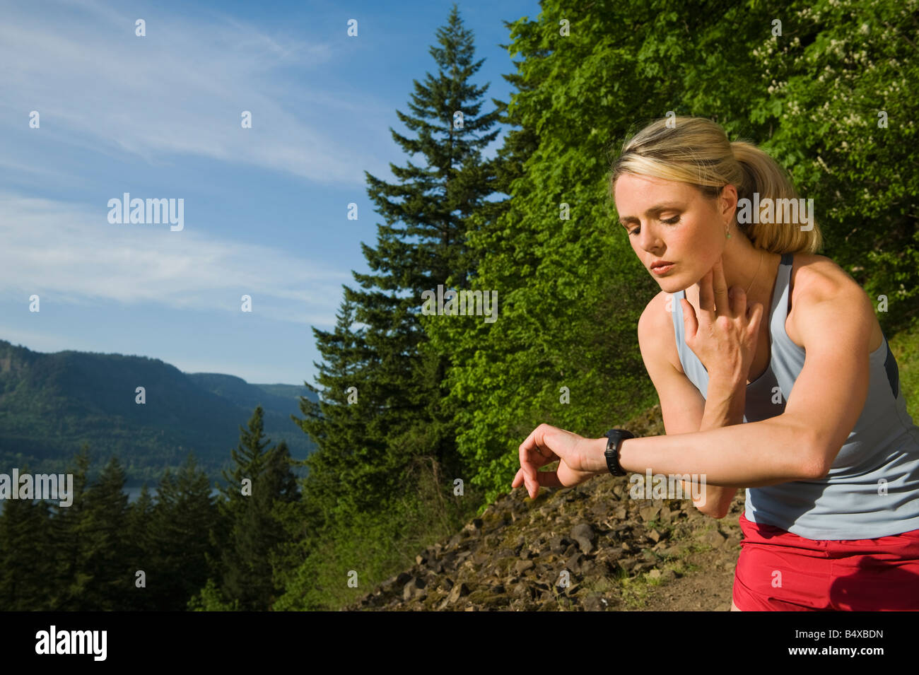 Runner checking heart rate Stock Photo - Alamy