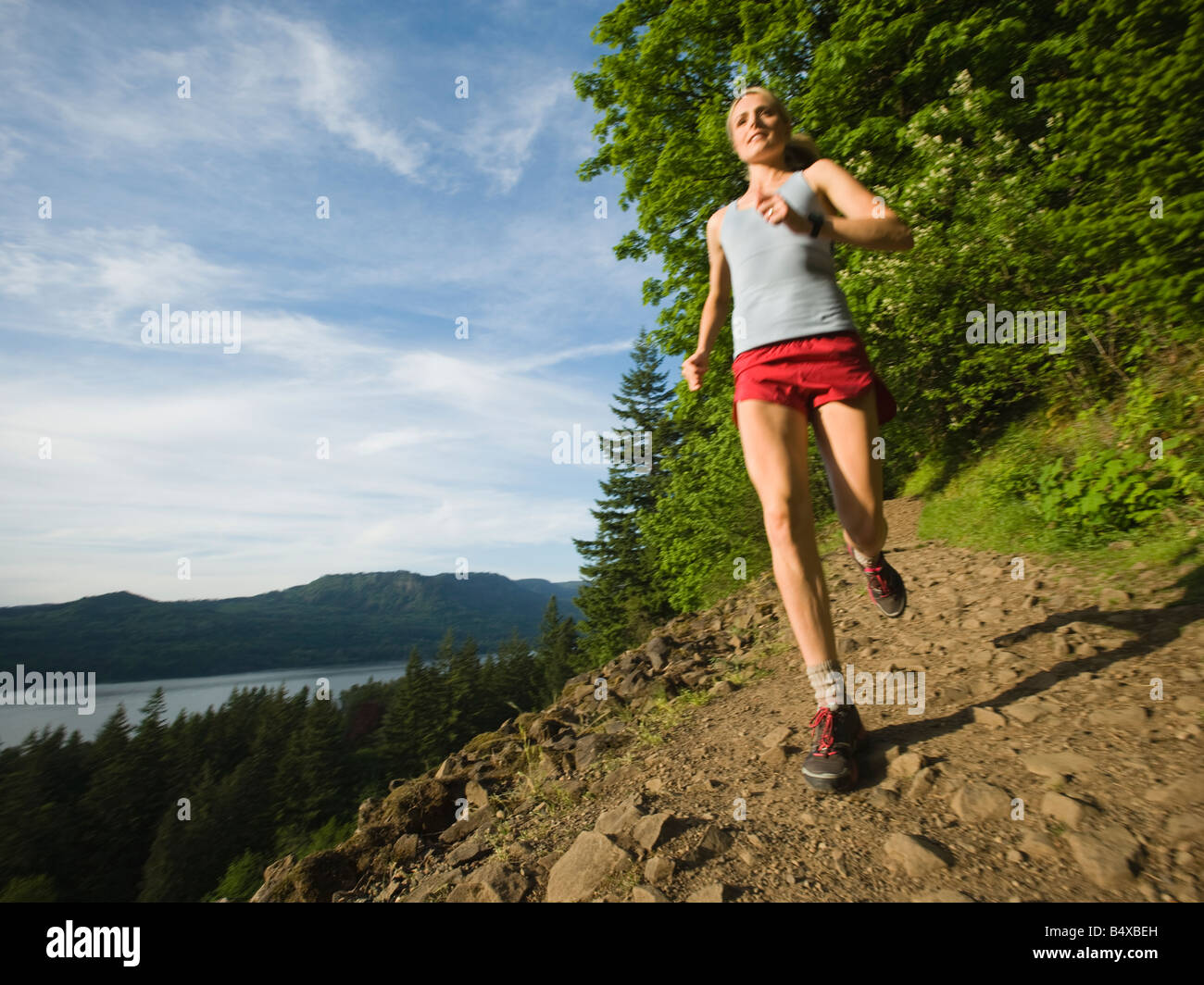 Runner on rocky trail Stock Photo - Alamy