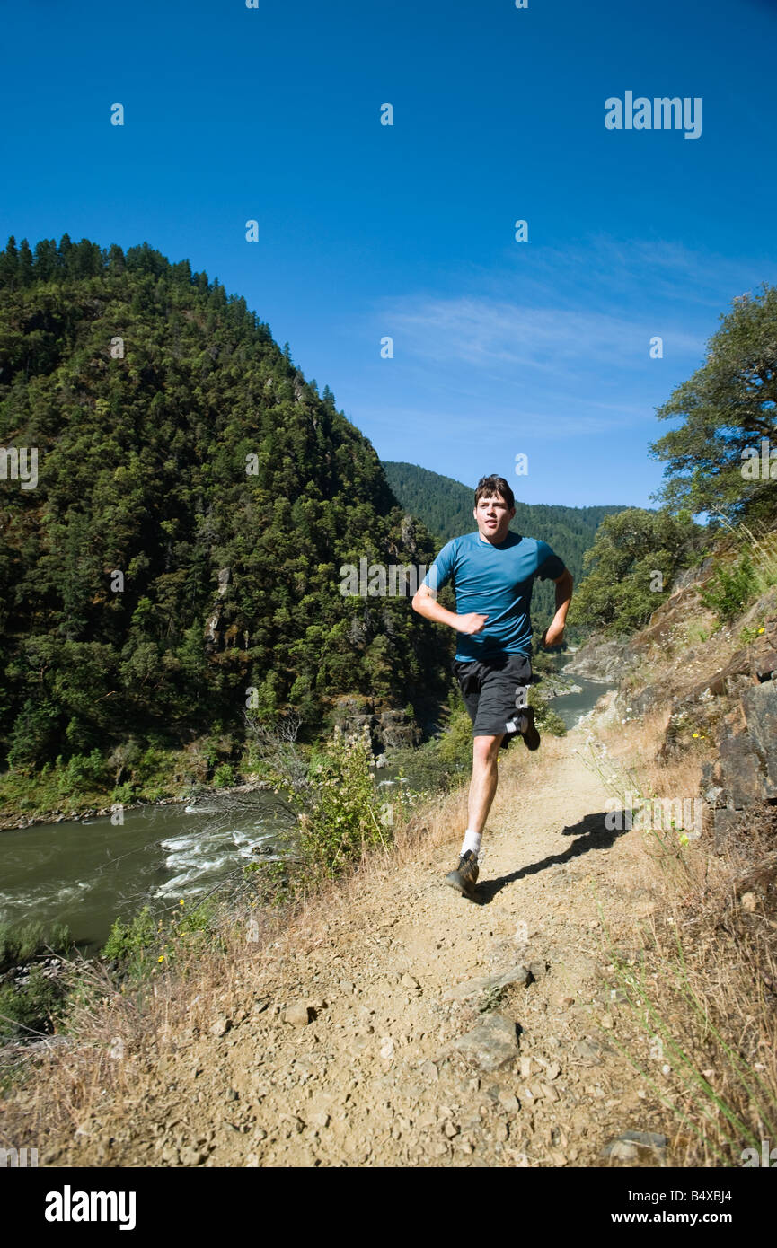 Man running on riverside trail Stock Photo - Alamy