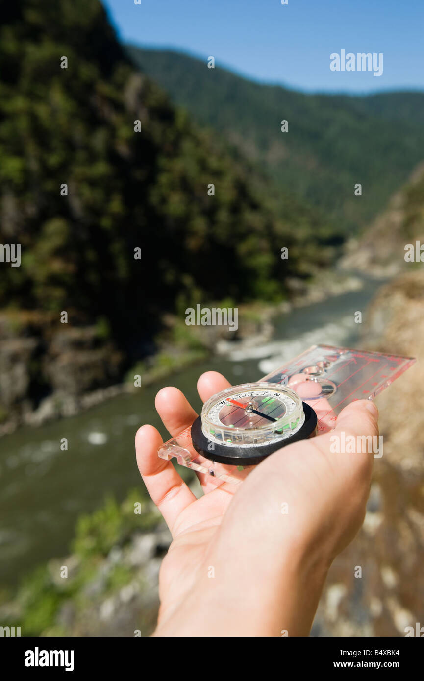 Hiker holding compass Stock Photo - Alamy