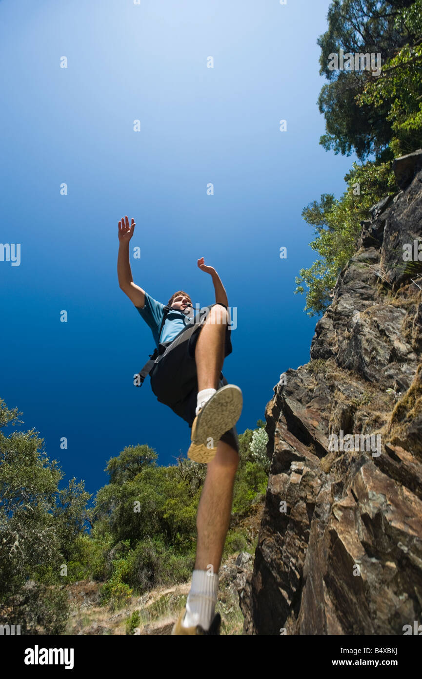 Hiker jumping down rocky trail Stock Photo - Alamy