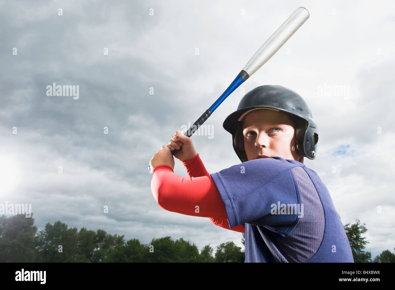 Baseball player reading to swing bat Stock Photo - Alamy