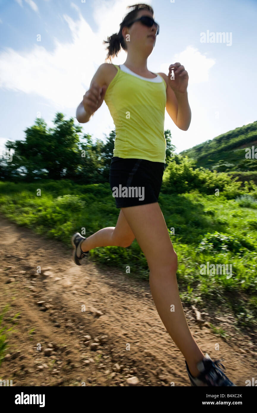 Young woman running on trail Stock Photo - Alamy