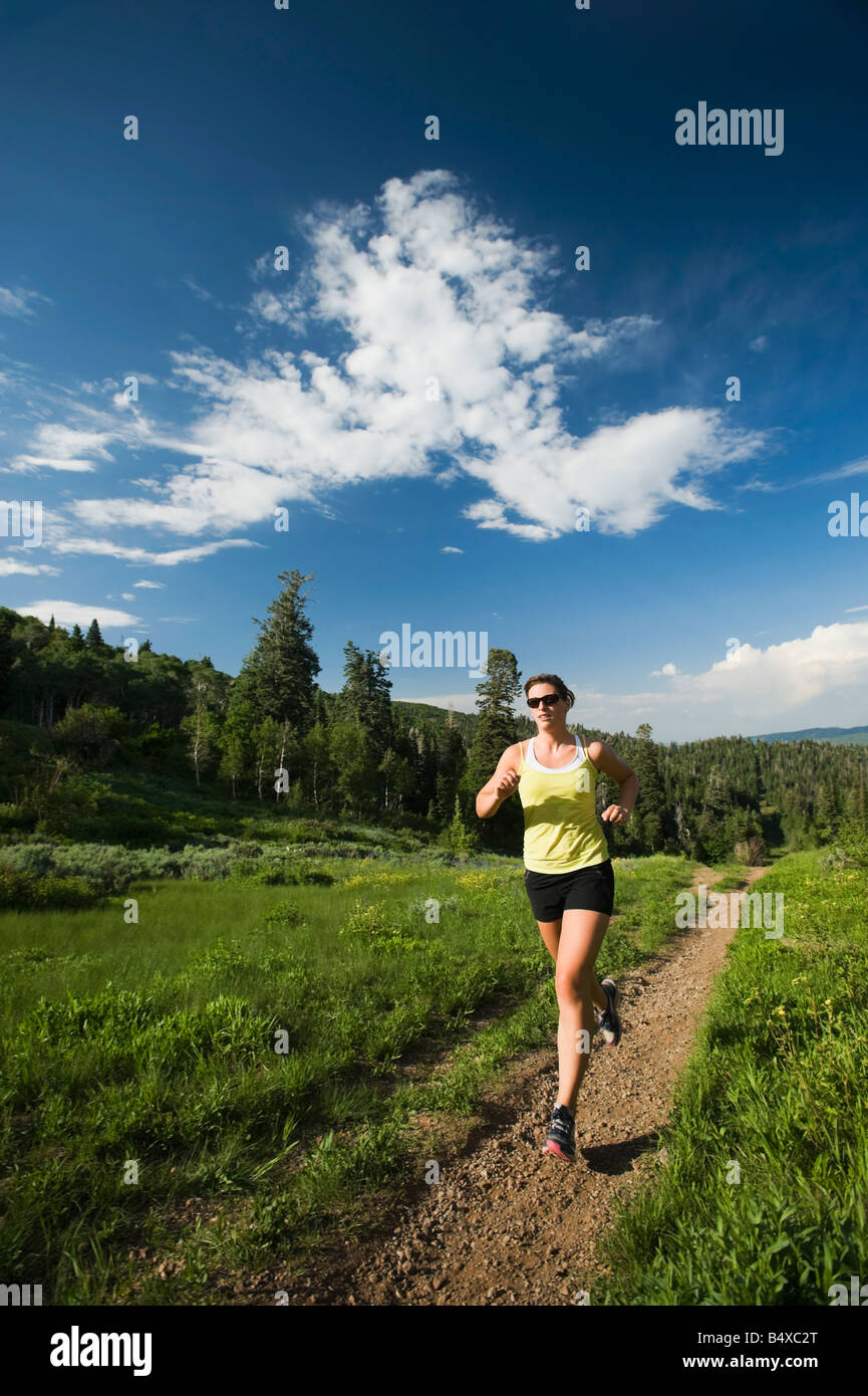 Young woman running on trail Stock Photo - Alamy