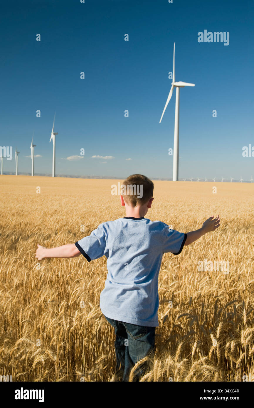 By running through field on wind farm Stock Photo - Alamy