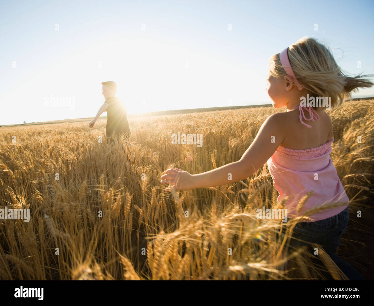 Children running through tall wheat hi-res stock photography and images ...