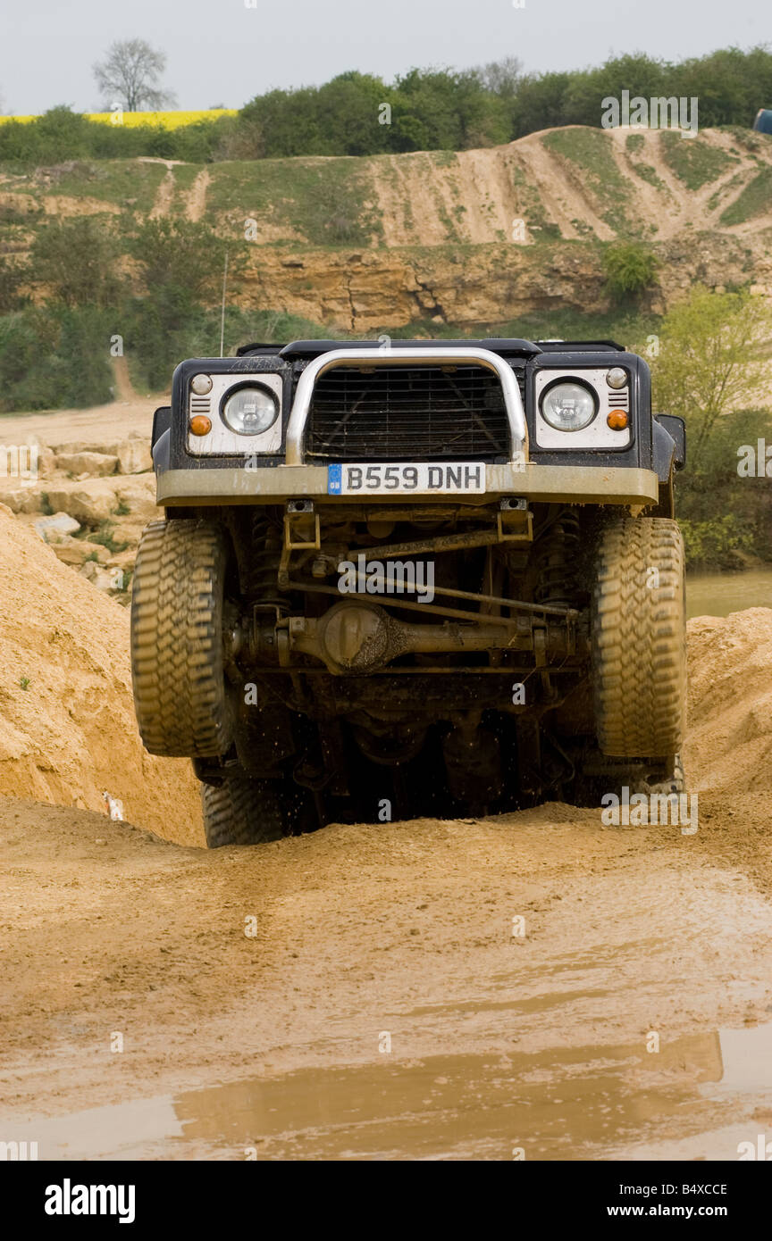Land Rover defender driving off road climbing a steep hill Stock Photo ...
