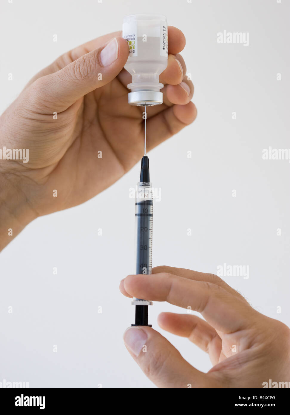 Close up of man filling syringe Stock Photo - Alamy