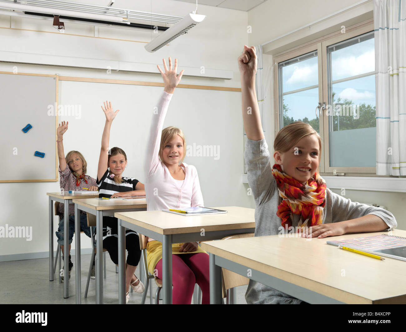 Four students in a classroom Stock Photo - Alamy