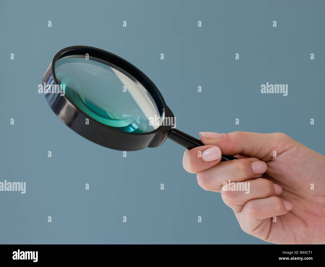 Close up of hand holding magnifying glass Stock Photo - Alamy