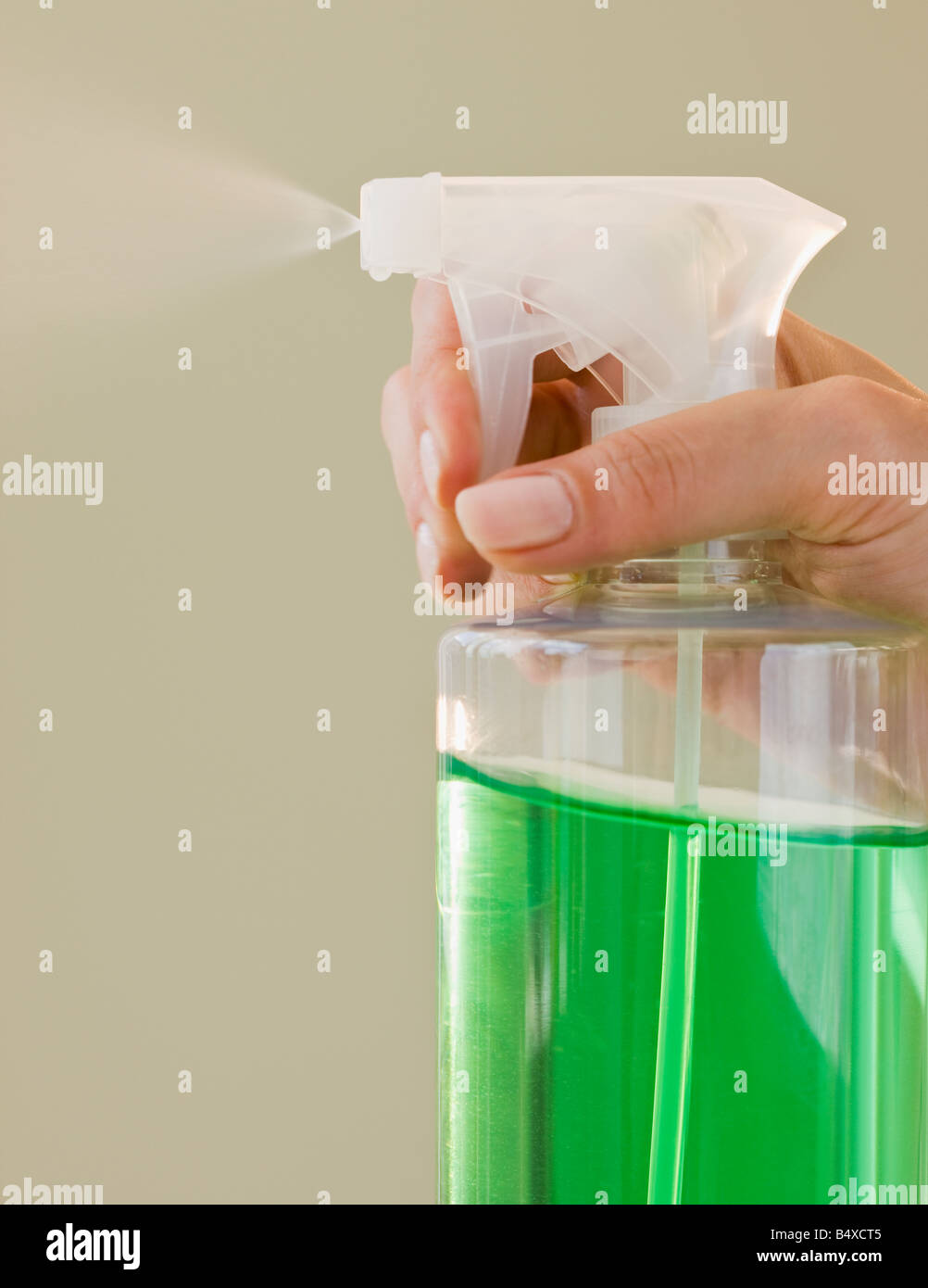 Close up of hand and spray bottle Stock Photo - Alamy