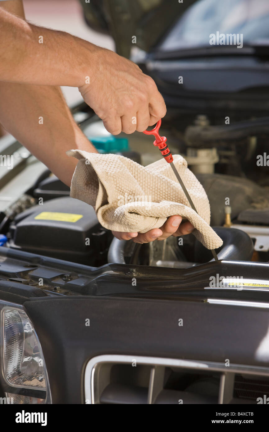 Mechanic checking oil Stock Photo - Alamy