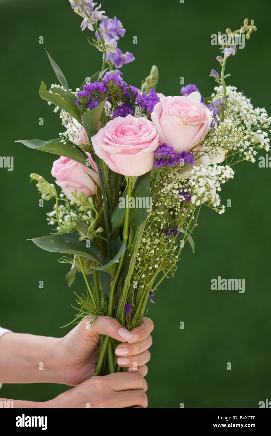 Woman holding bouquet of flowers Stock Photo - Alamy