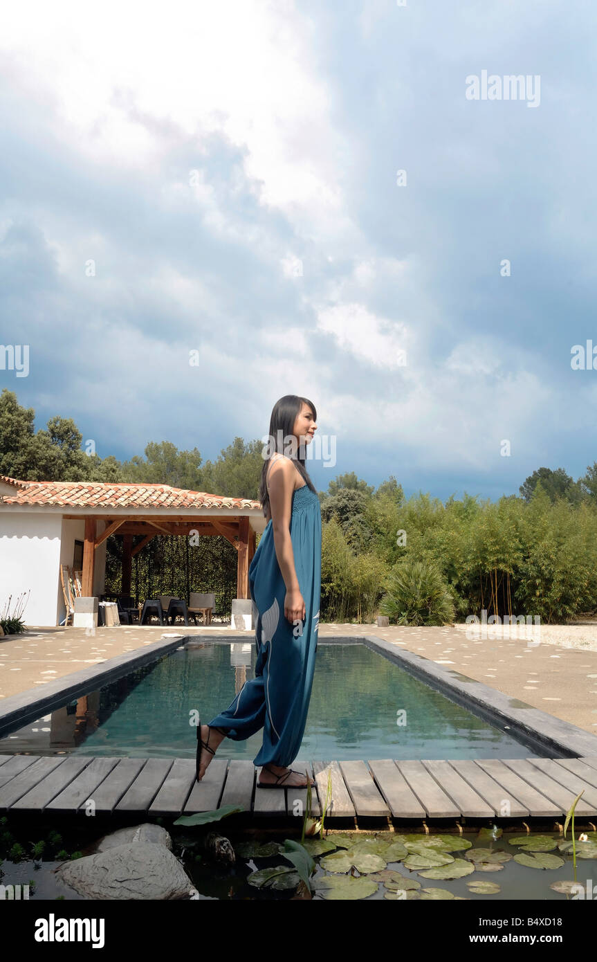 Woman walking near swimming pool Stock Photo - Alamy