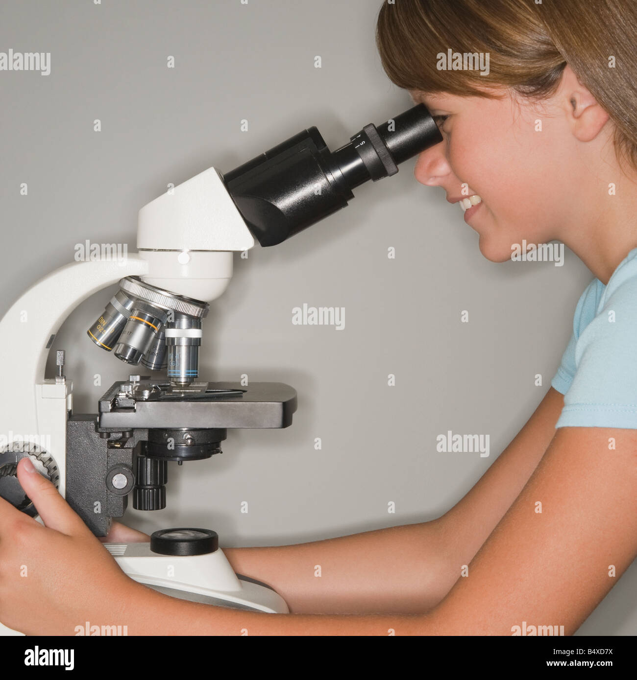 Girl using microscope Stock Photo - Alamy