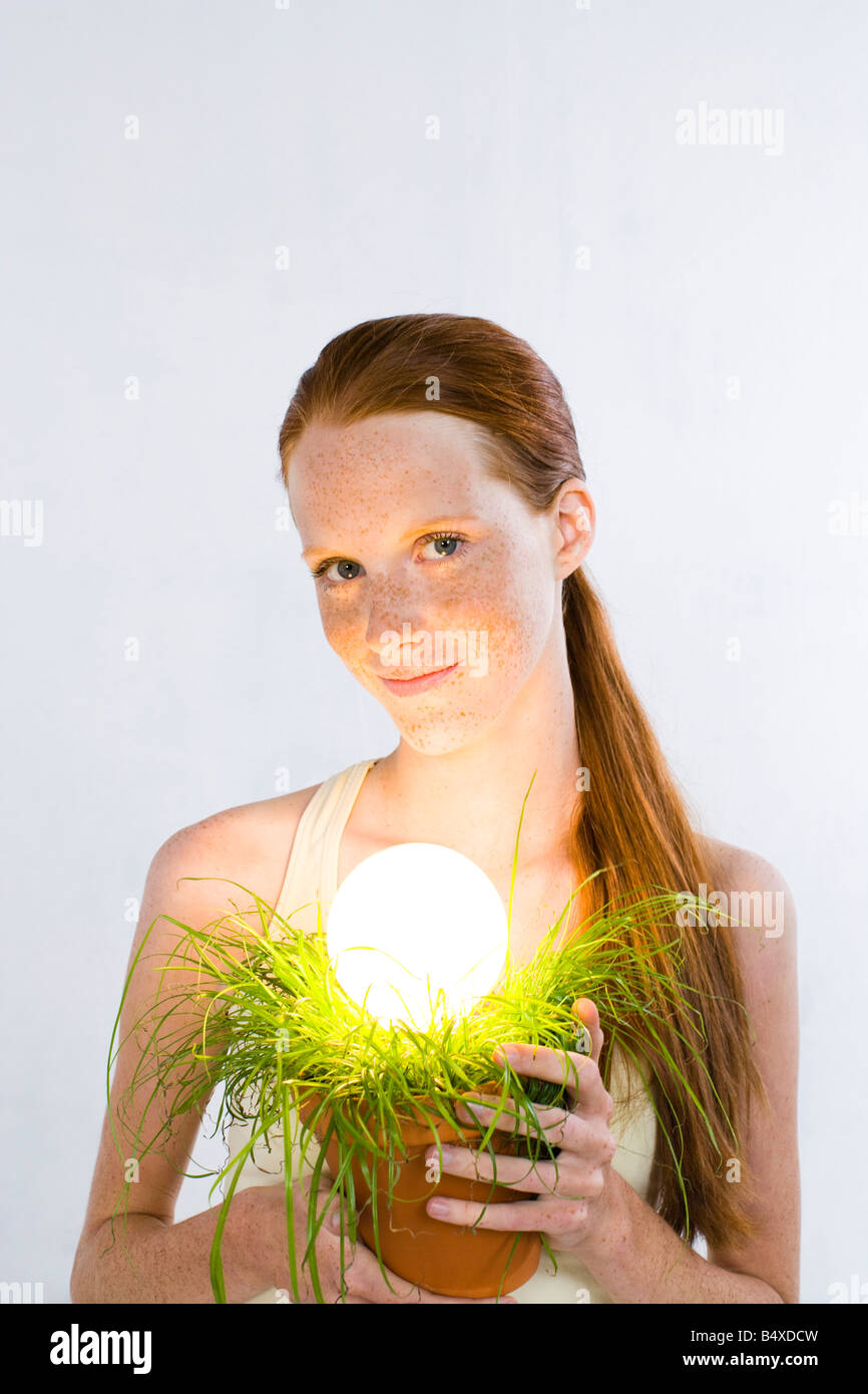 woman with energy saving light bulb in plant Stock Photo - Alamy