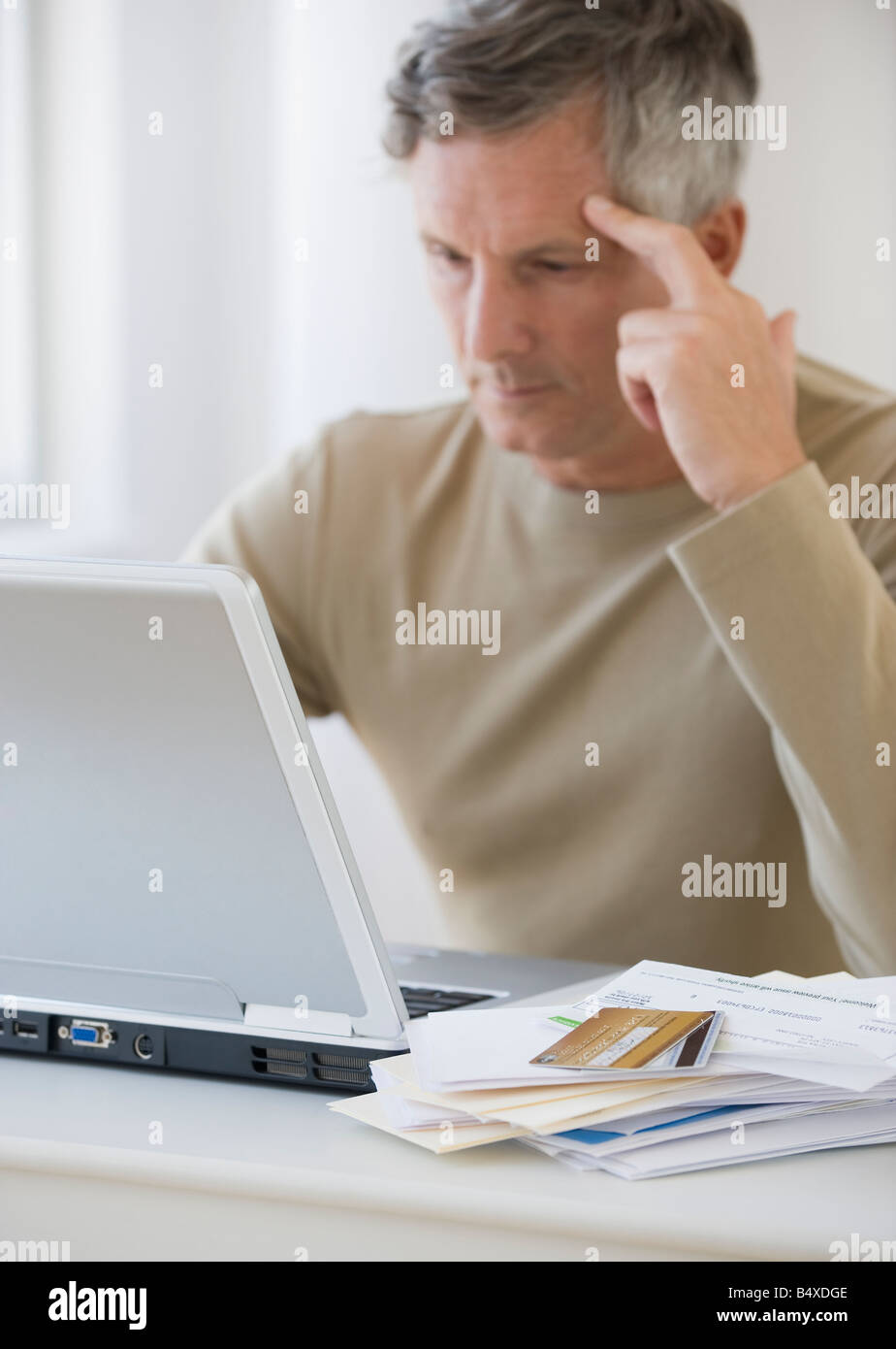 Man paying bills online Stock Photo - Alamy