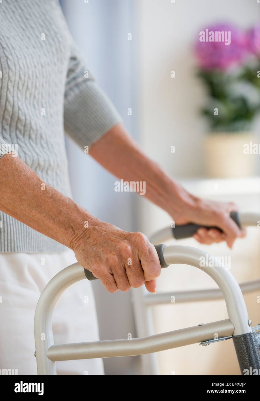 Senior woman using walker Stock Photo - Alamy