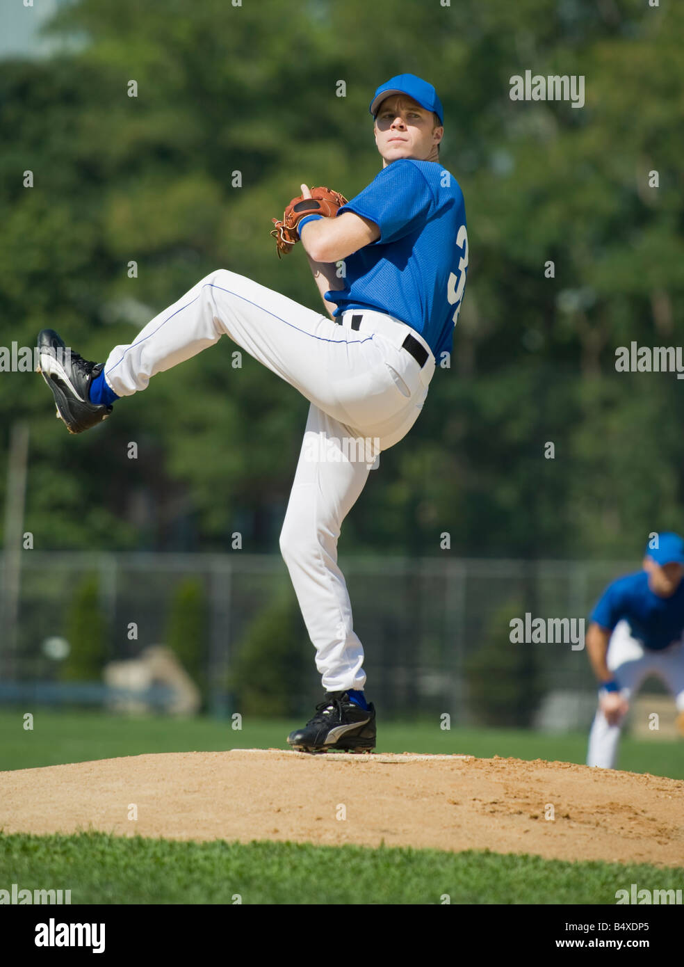 Baseball pitcher preparing to pitch ball Stock Photo - Alamy