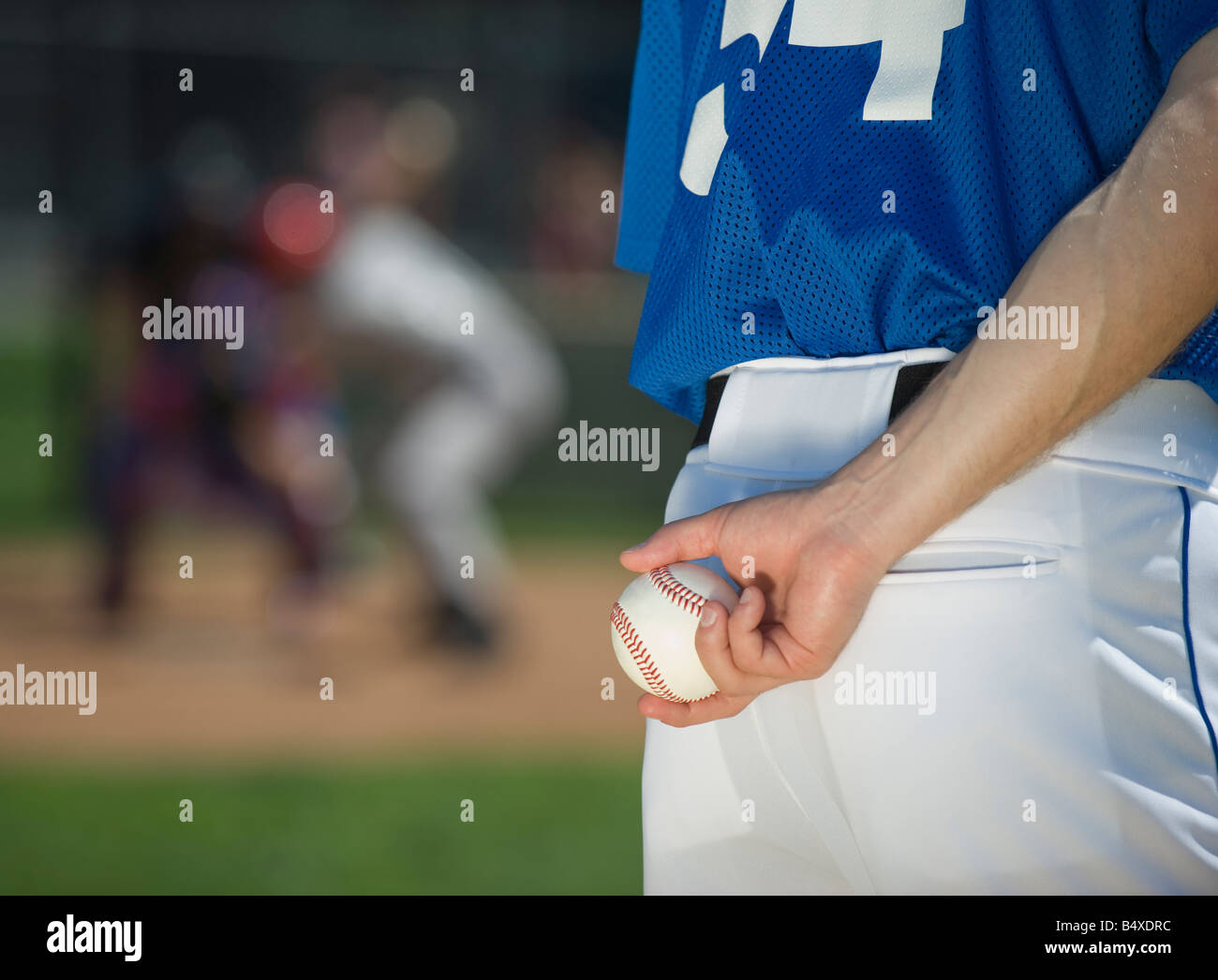 Baseball pitcher preparing to pitch ball Stock Photo - Alamy