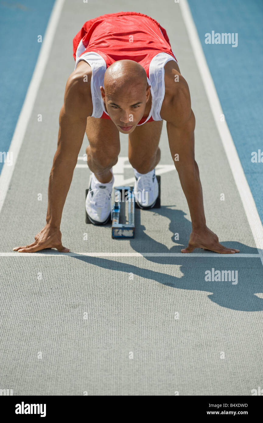 Runner on starter block Stock Photo - Alamy