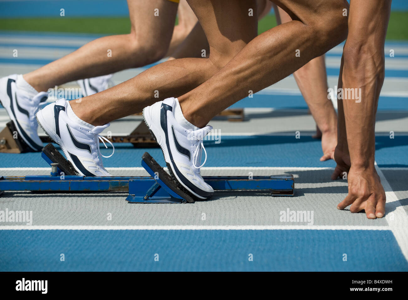 Runners on starter block Stock Photo - Alamy