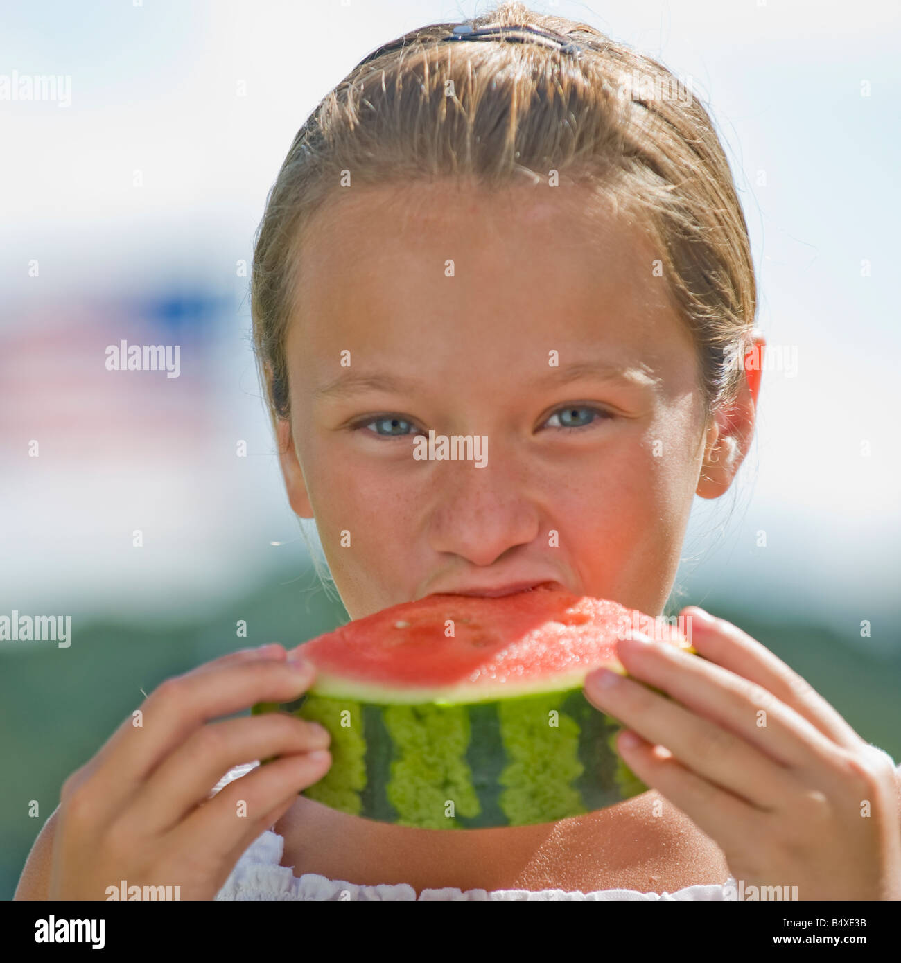 Girl eating watermelon outdoors Stock Photo - Alamy