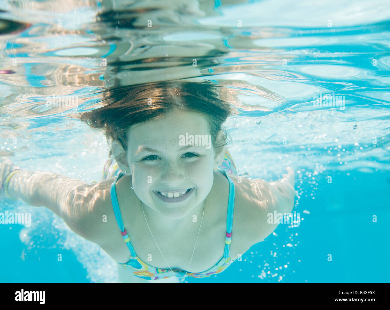 Girl swimming underwater Stock Photo - Alamy