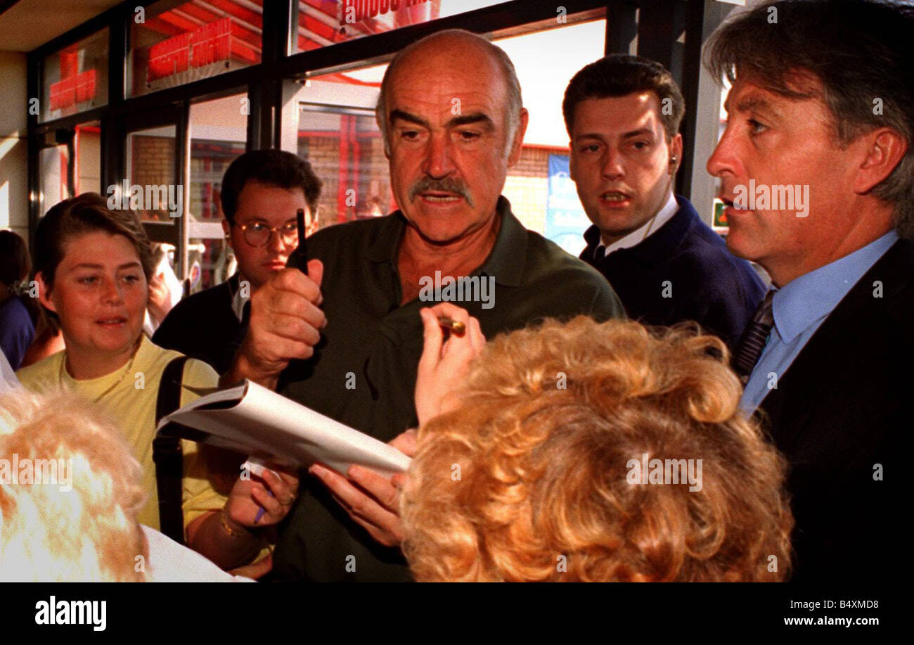 Sean Connery with moustache and mouth open holding a pen and notepad at ...