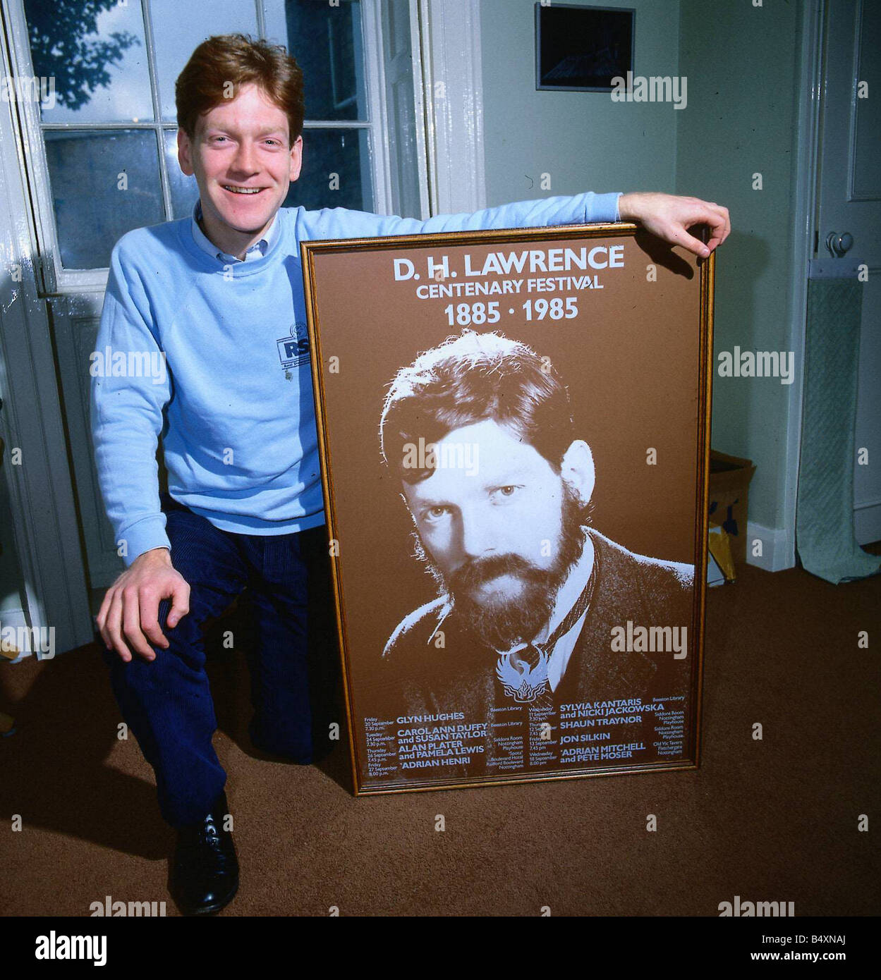 Kenneth Branagh actor director 1985 with large poster of D H Lawrence ...