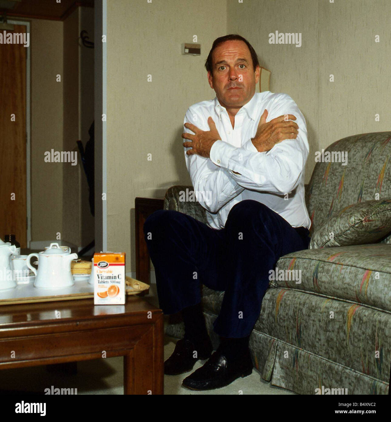 John Cleese with arms wrapped around himself August 1988 Stock Photo ...