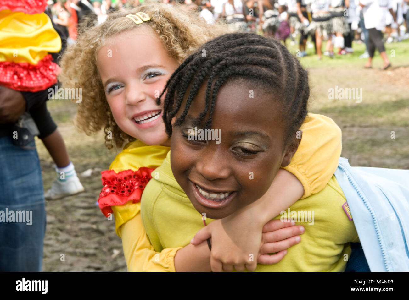 Two girls paying at West Indian Carnival Leeds West Yorkshire England ...