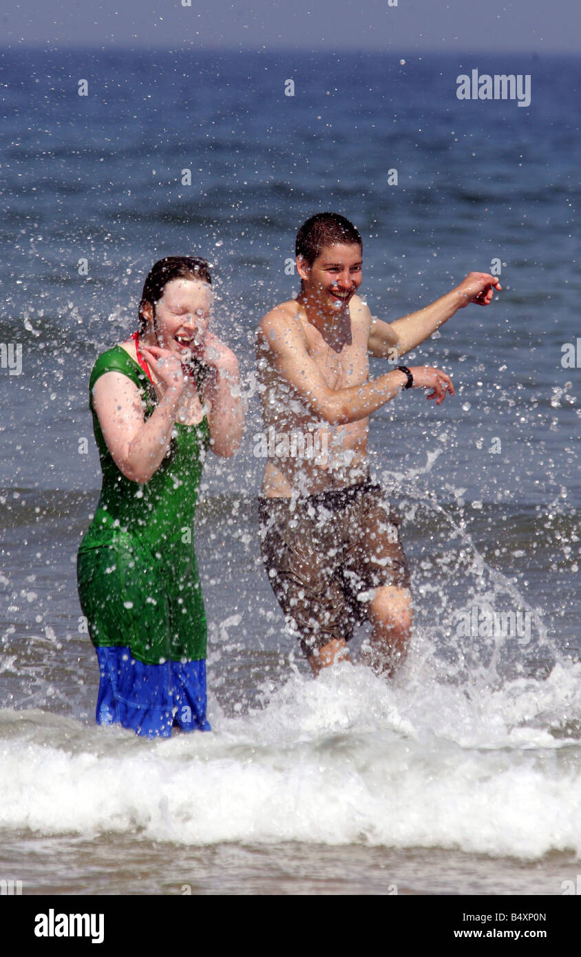 Students Matthew Bagshaw and Katie Cook splash about in the sea at ...