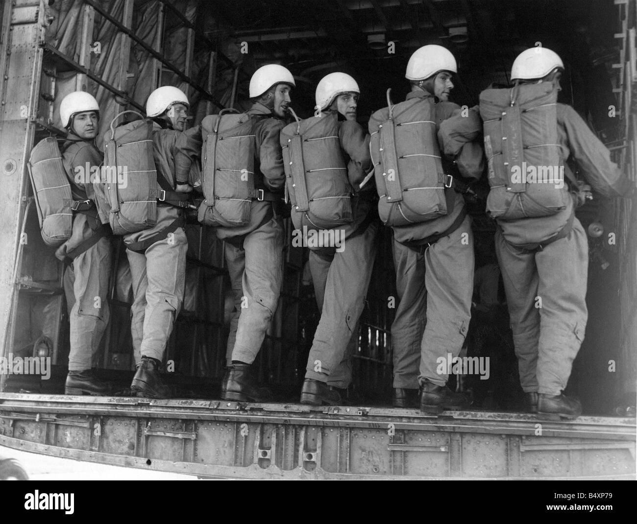 A team from the Parachute Regiment with arms linked prepare to jump ...