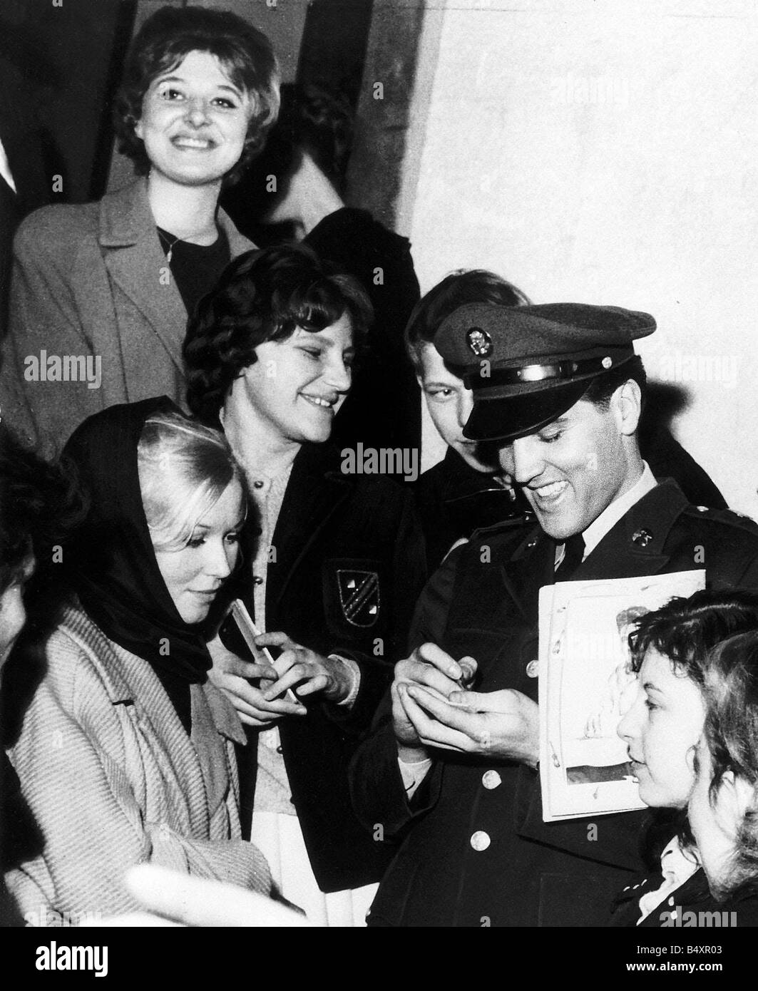Elvis Presley signing autographs while in Germany on service with the U ...