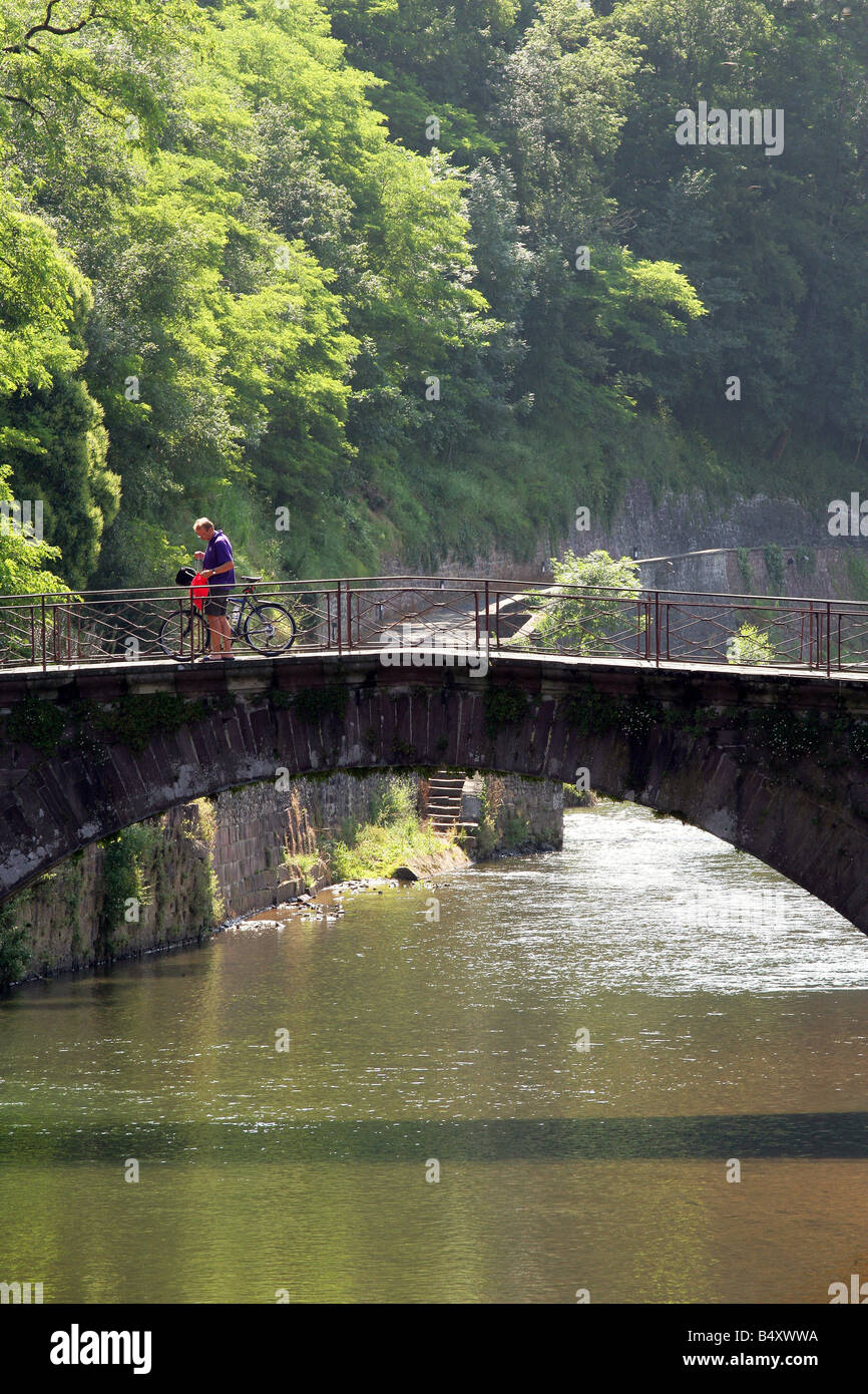 One adult man crossing bridge over a river Stock Photo - Alamy