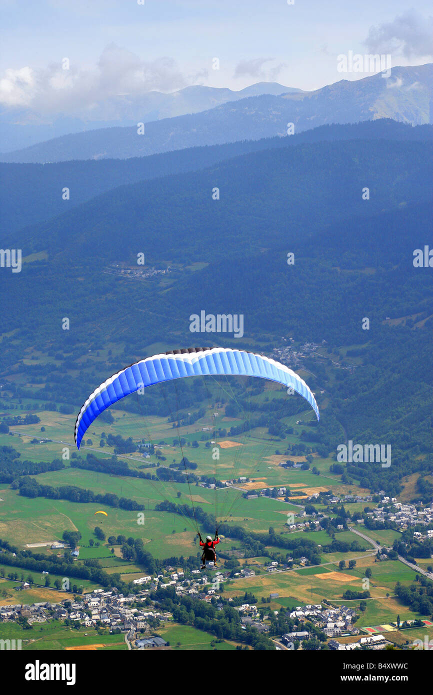 Man paragliding above a town Stock Photo - Alamy