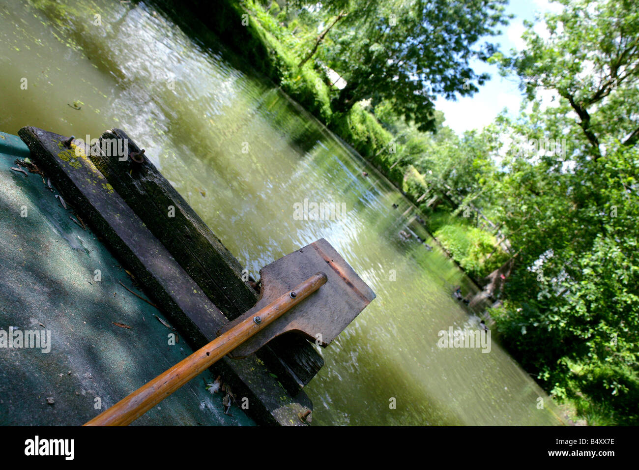 Wooden raft with oar on river Stock Photo - Alamy