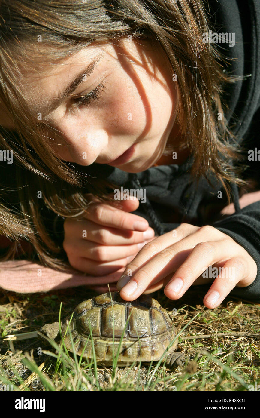 Girl playing with turtle Stock Photo - Alamy