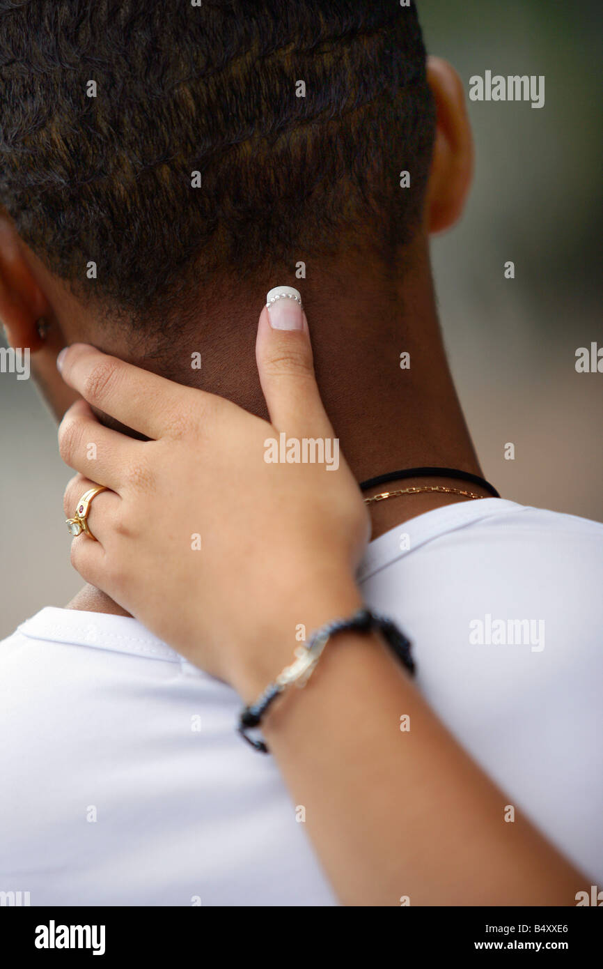Woman stroking man's neck Stock Photo - Alamy
